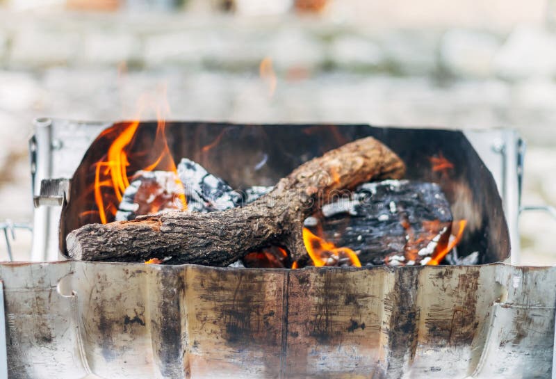 A Homemade Barbecue with Burning Wood. Concept of Making a Fire at Home ...