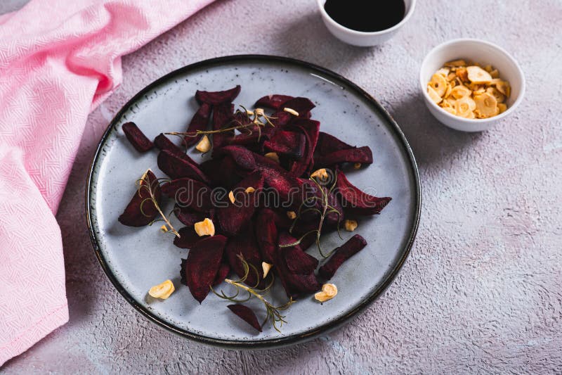 Homemade Beet Chips with Rosemary and Garlic on a Plate on the Table ...