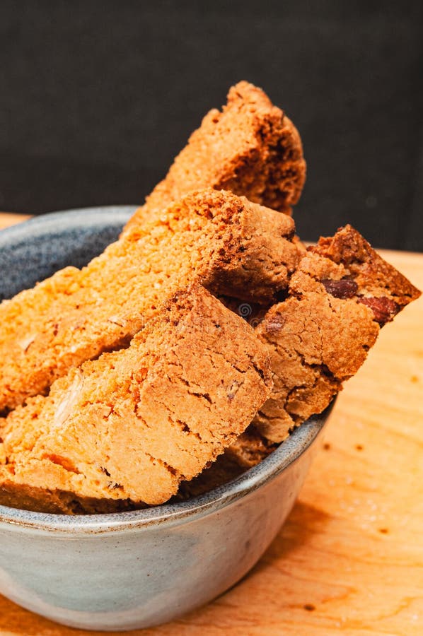 Homemade Biscottes, in Blue Ceramic Bowl, on Wood Cutting Board Stock ...