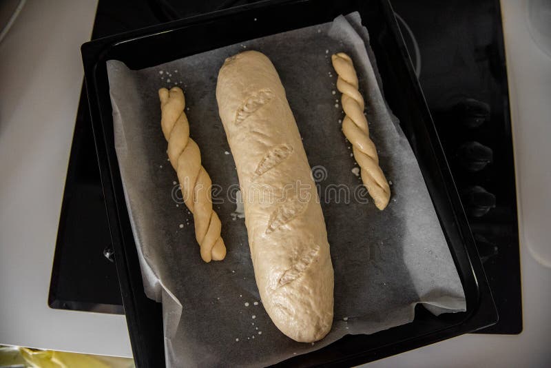 Homemade Bread and Braids Resting on Baking Sheet, Ready for Oven Stock ...