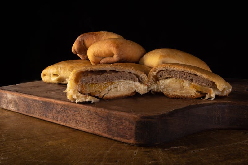 Homemade Bread Stuffed with Hamburger, Cheese and Tomato, on a Cutting ...