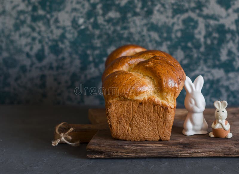 Homemade Brioche and Ceramic Easter Rabbits on a Rustic Cutting Board ...