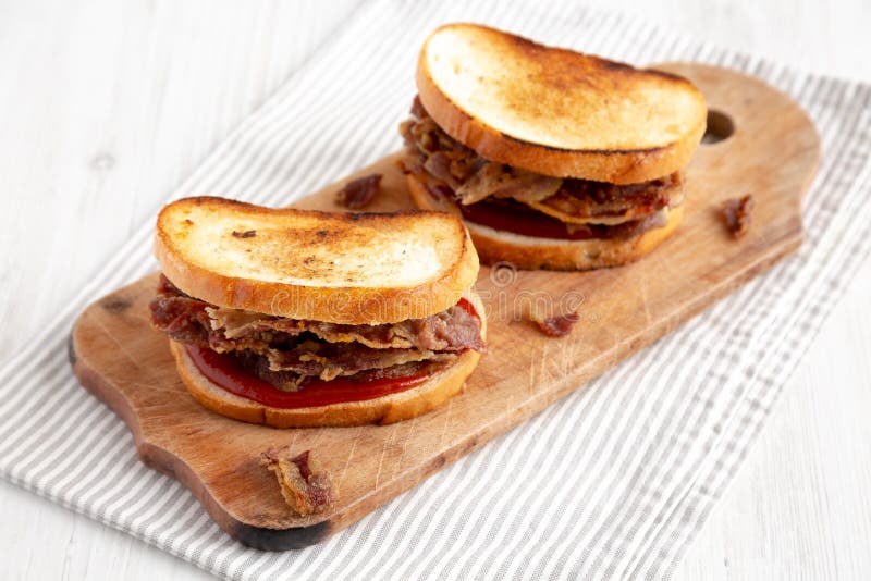 Homemade British Bacon Sandwich on a Rustic Wooden Board, Side View ...