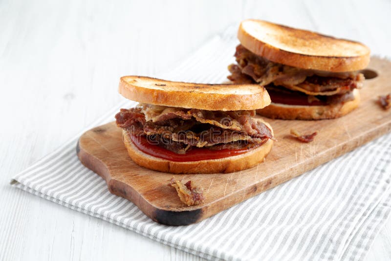 Homemade British Bacon Sandwich on a Rustic Wooden Board, Side View ...