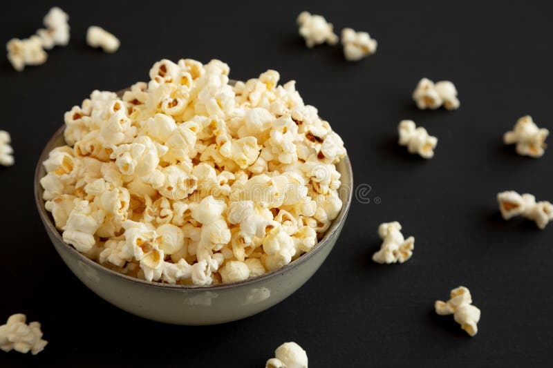 Homemade Buttered Popcorn with Salt in a Bowl on a Black Background ...