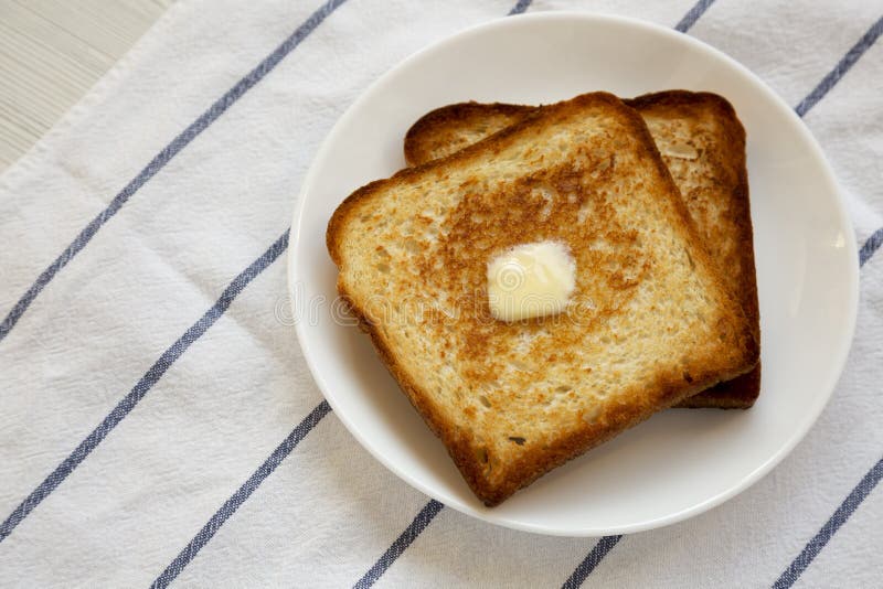 Homemade Buttered Toast on a White Plate, High Angle View Stock Image ...