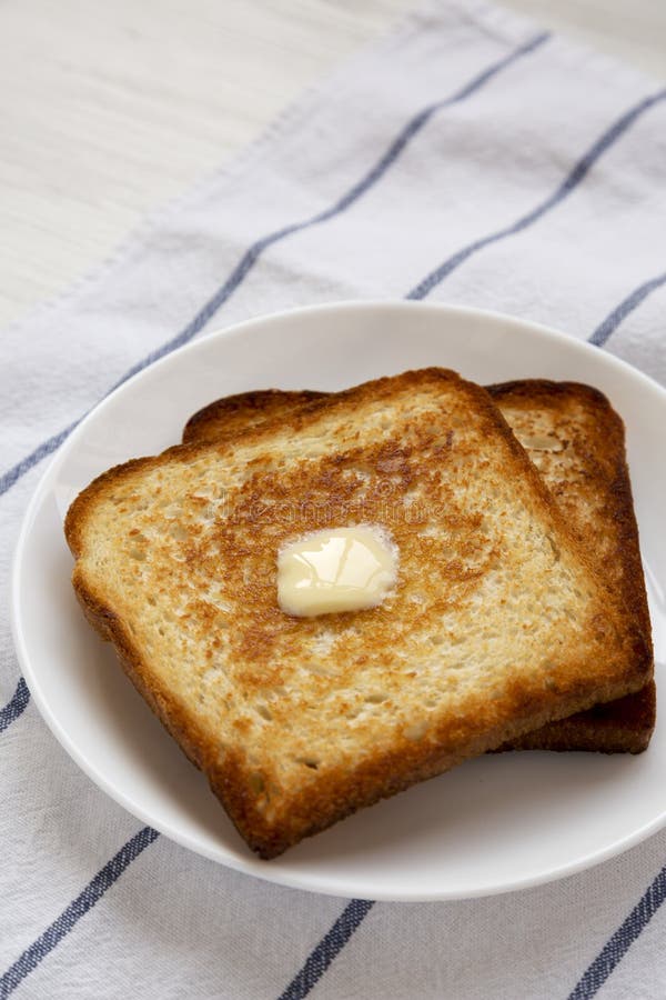 Homemade Buttered Toast on a White Plate on a Black Background, Top ...
