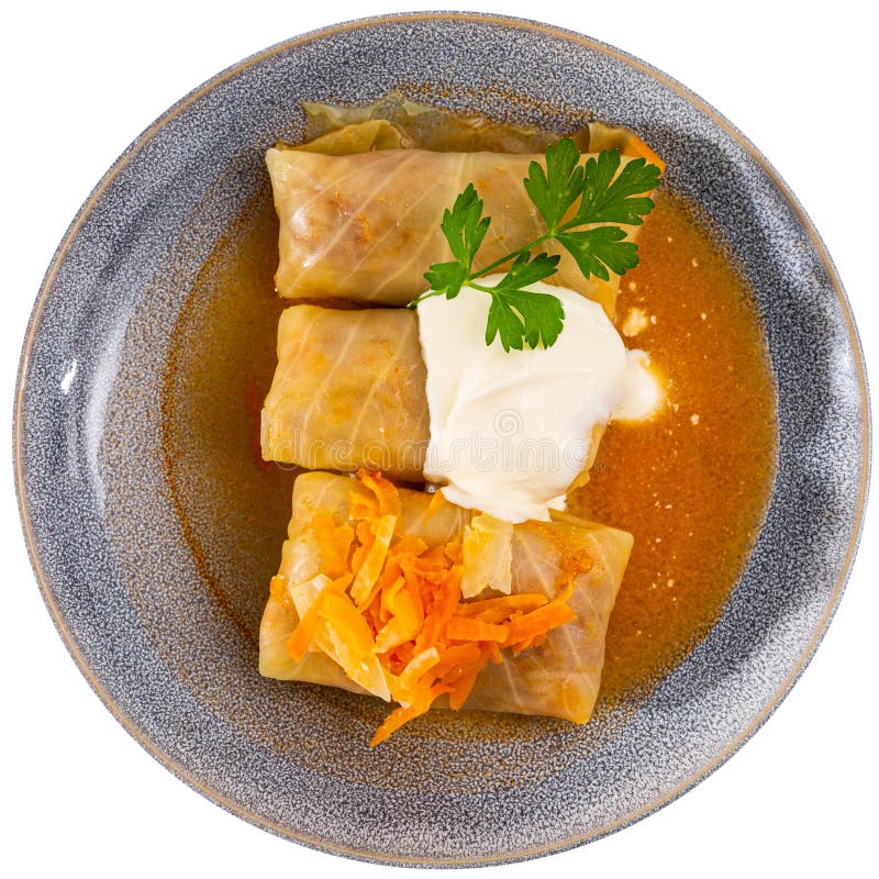 Homemade Cabbage Rolls In Leaves Of Cabbage At Plate With Sour Cream
