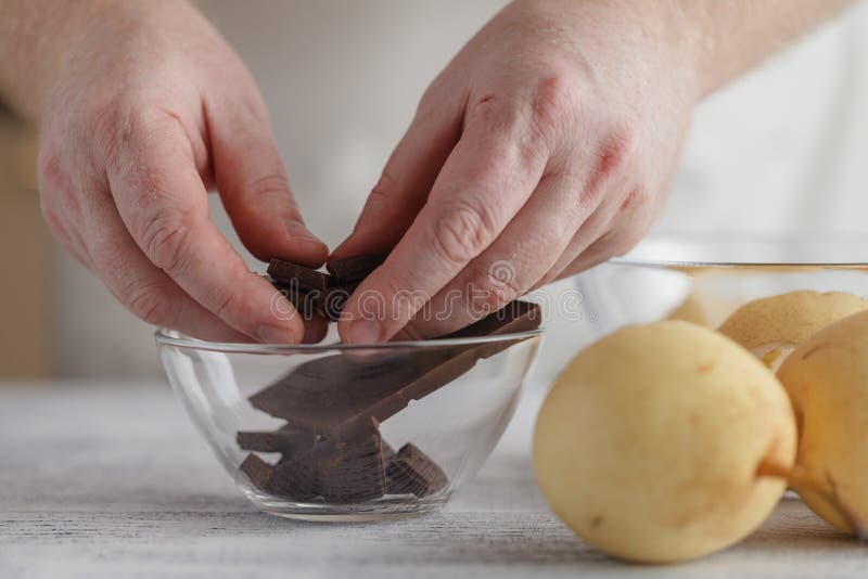 Homemade Chocolate Syrup Dripping from a Spoon into a Bowl / a M Stock ...