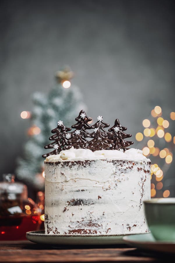 Christmas Cake with Chocolate Christmas Trees on a Wooden Table with ...