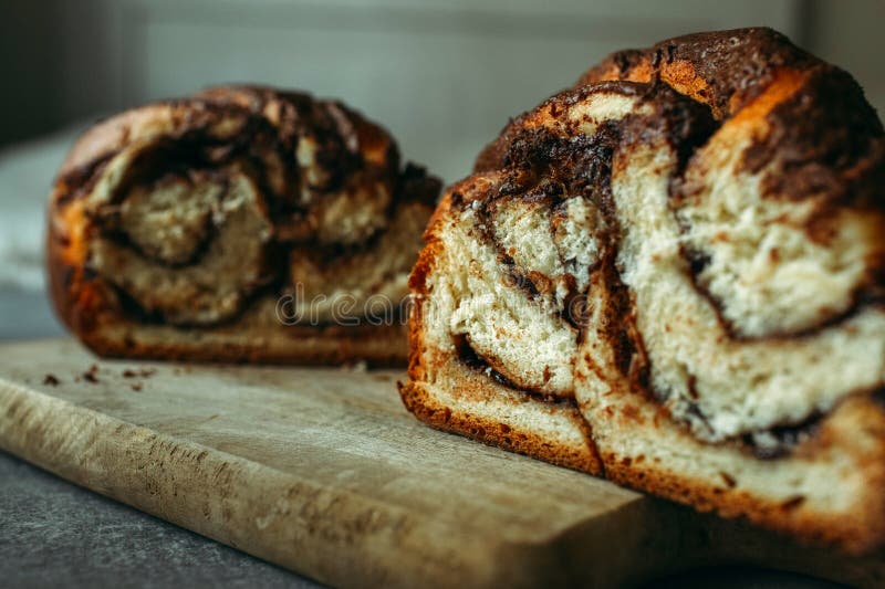 A Homemade Cinnamon Roll, Cut in Half, Lies on the Kitchen Cutting ...