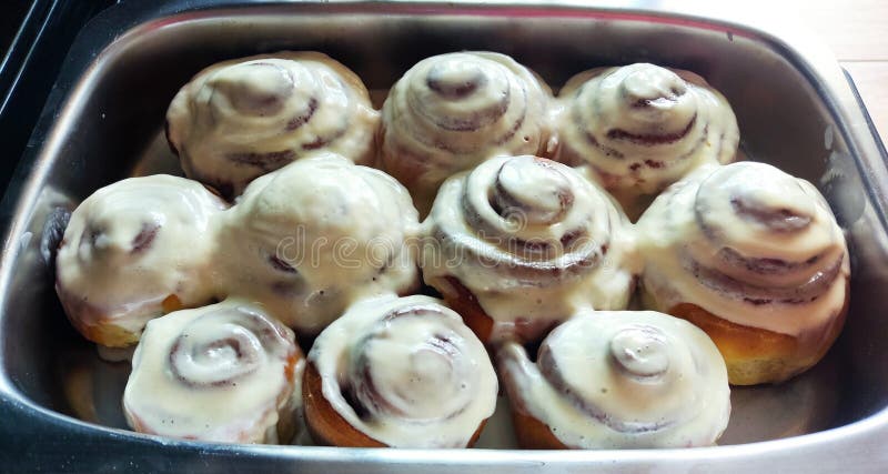Homemade Cinnamon Rolls Coated in White Frosting Stock Photo - Image of ...