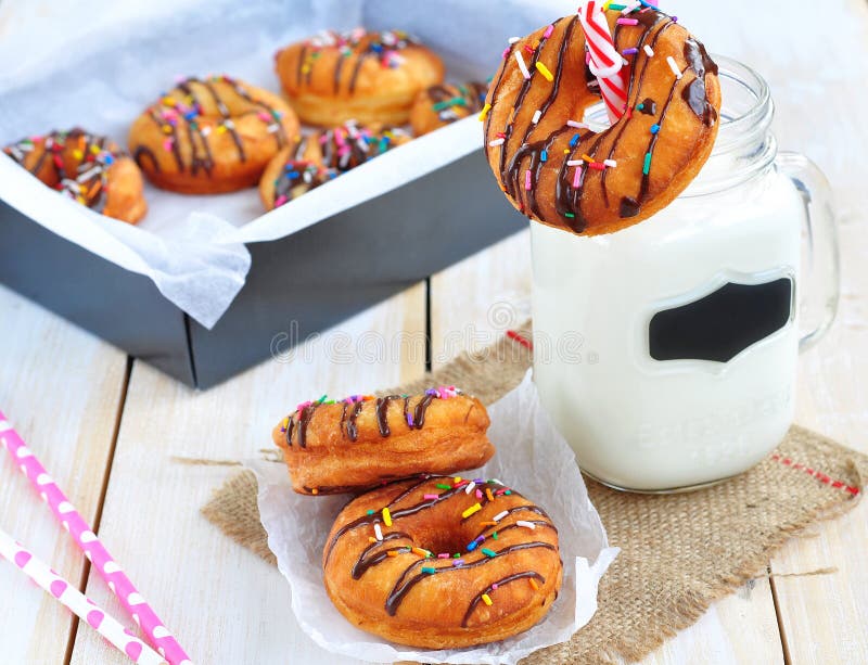 Homemade Donuts with Colorful Icing Sitting on White Wooden Table Stock ...