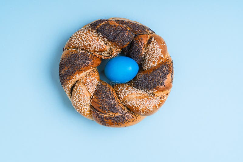 Homemade Easter Bread Ring with Handmade Dyed Egg on Light Blue ...