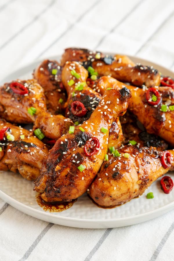 Homemade Easy Sticky Chicken Drumsticks on a Plate, Side View. Close-up ...
