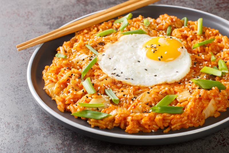 Homemade Kimchi Fried Rice Topped with Fried Egg Closeup on the Plate ...