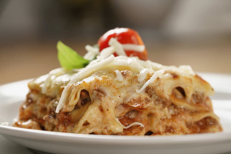 Homemade Lasagna Portion on White Plate on Wood Table Stock Photo ...