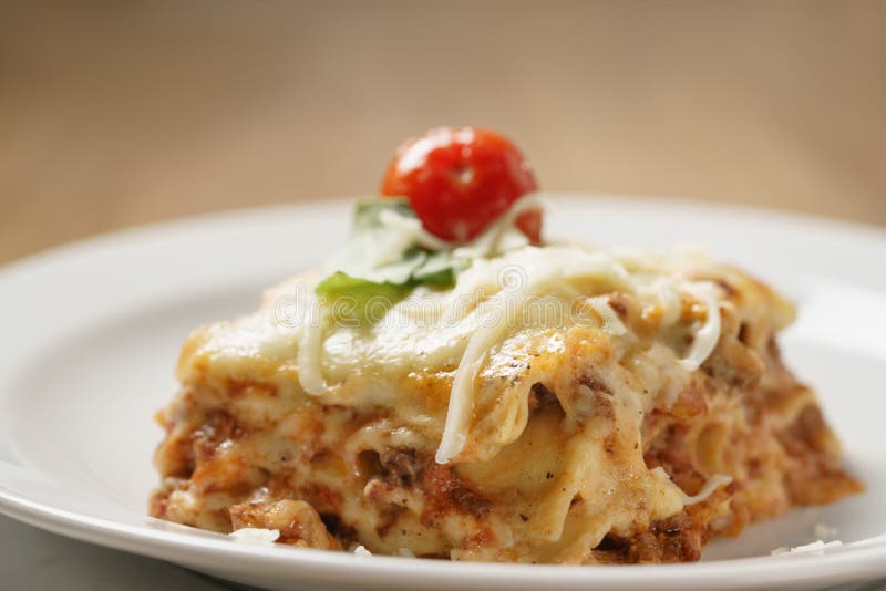 Homemade Lasagna Portion on White Plate on Wood Table Stock Photo ...