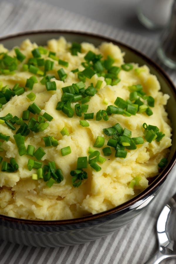 Homemade Mashed Potatoes with Chives in a Bowl, Side View. Close-up ...