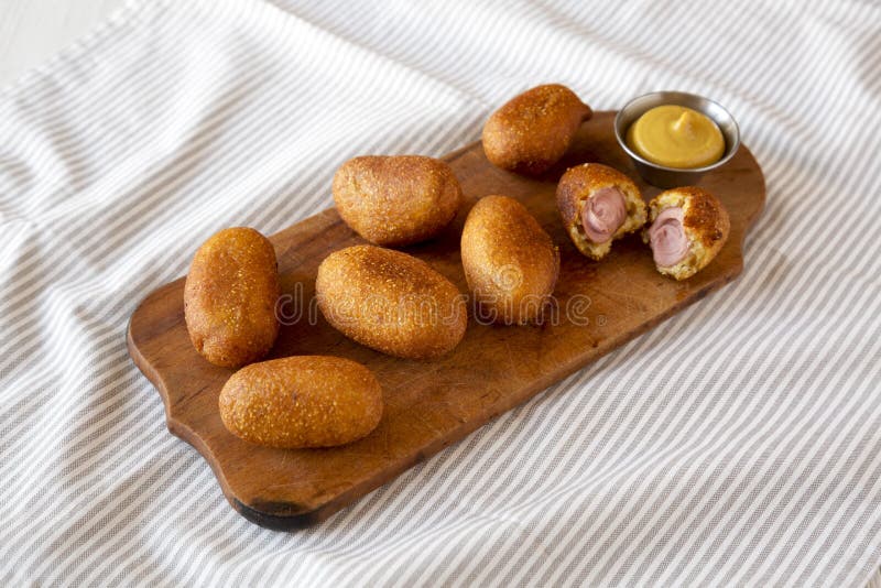 Homemade Mini Corn Dogs on a Rustic Wooden Board, Side View Stock Photo ...