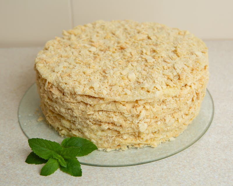 Homemade Napoleon Cake Stands on the Table in the Kitchen. it is ...