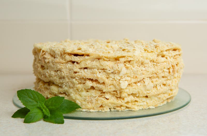 Homemade Napoleon Cake Stands on the Table in the Kitchen. it is ...