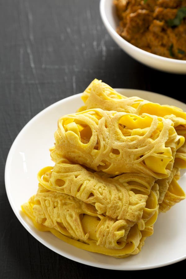 Homemade Net Crepe Roti Jala on a White Plate on a Black Surface, Low ...