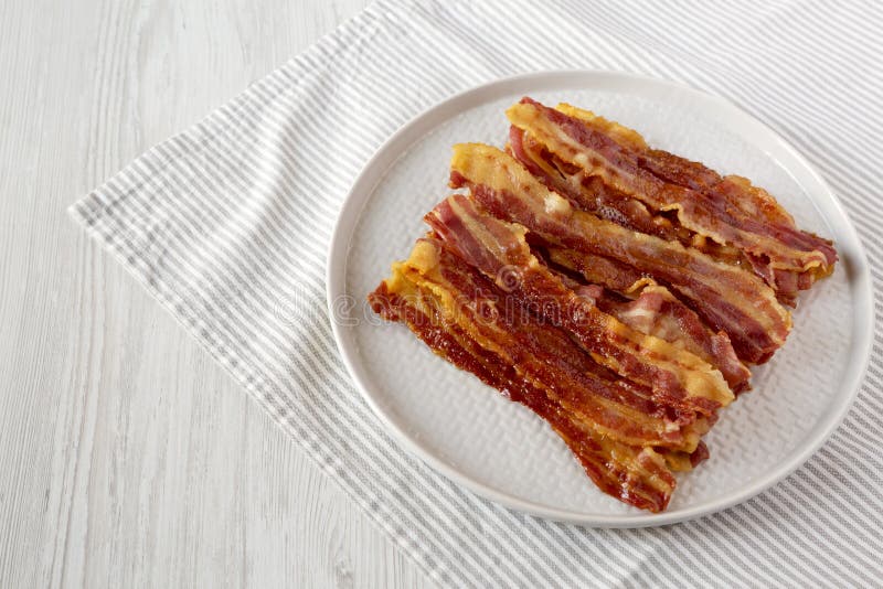 Homemade Oven Baked Bacon on a Gray Plate, Side View. Space for Text ...