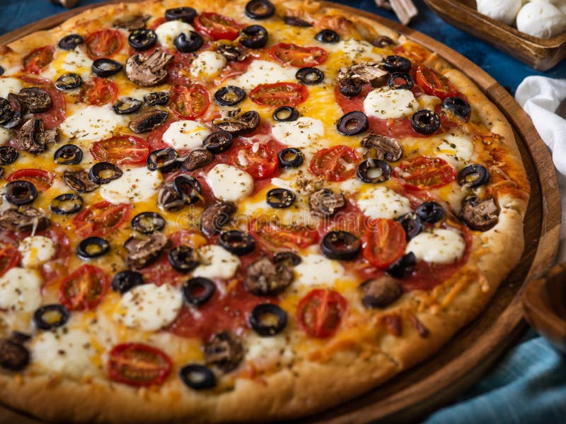 Homemade Pizza on a Blue Table with Ingredients Stock Image - Image of ...