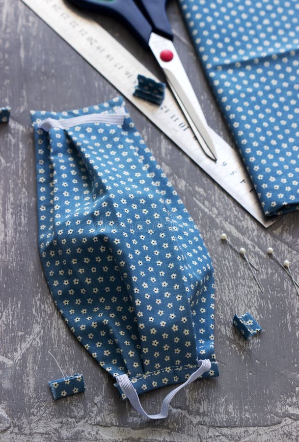 Homemade Protective Mask and Pieces of Cloth on a Gray Background Stock ...