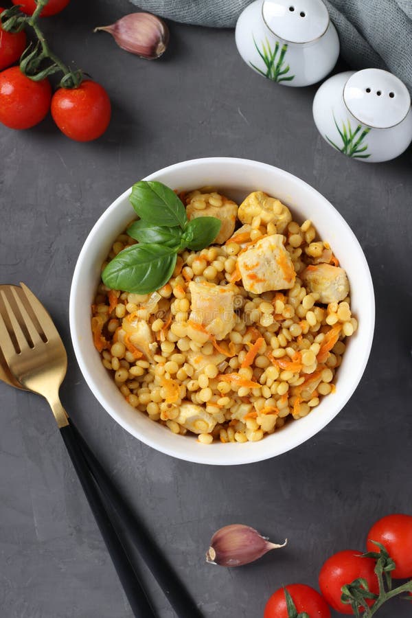 Homemade Ptitim Pasta with Chicken and Vegetables on Dark Gray Table ...