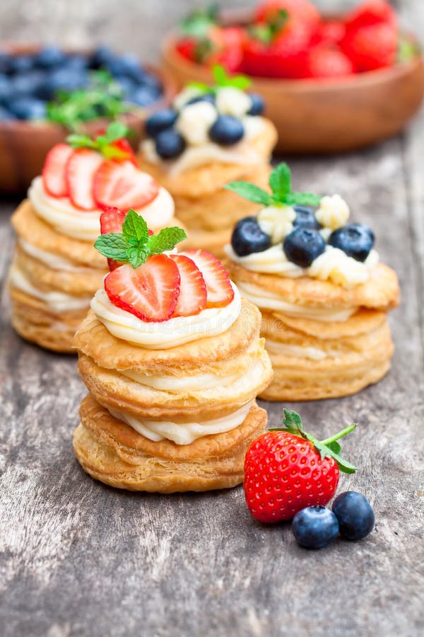 Homemade Puff Pastry Stuffed with Cream and Berries on the Rustic Table ...