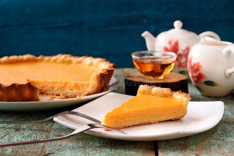 Homemade Pumpkin Pie and Black Tea on Old Table Painted Blue Stock ...