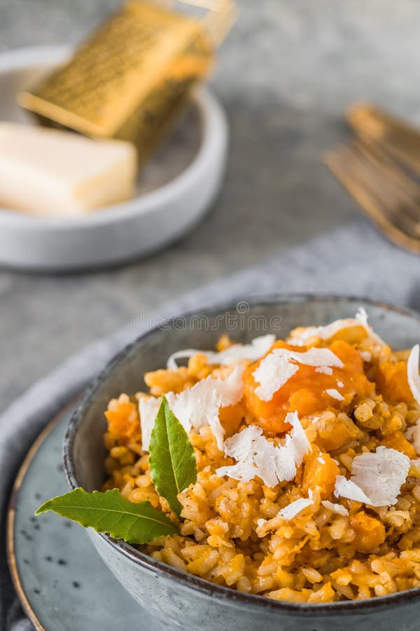 Homemade Pumpkin Risotto with Parmesan Cheese on a Gray Concrete ...