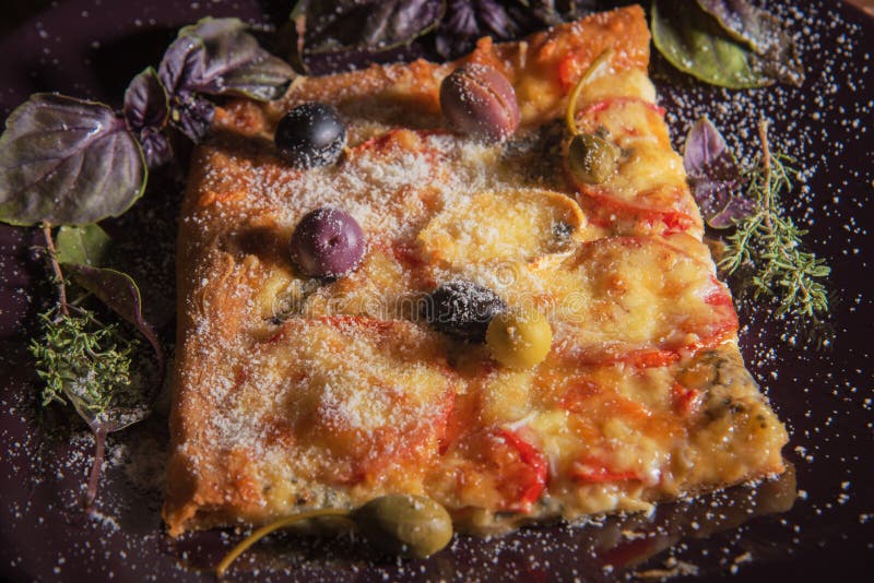 Homemade Rectangular Pizza on the Dark Plate with Olives and Parmesan ...
