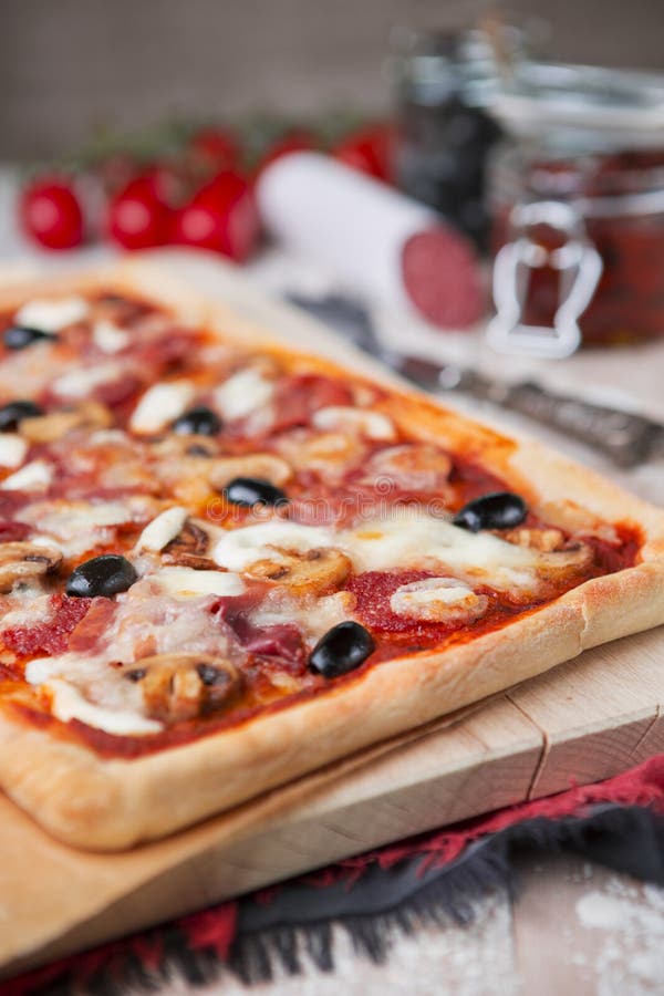 Homemade Rectangular Pizza on a Rustic Table Stock Image - Image of ...