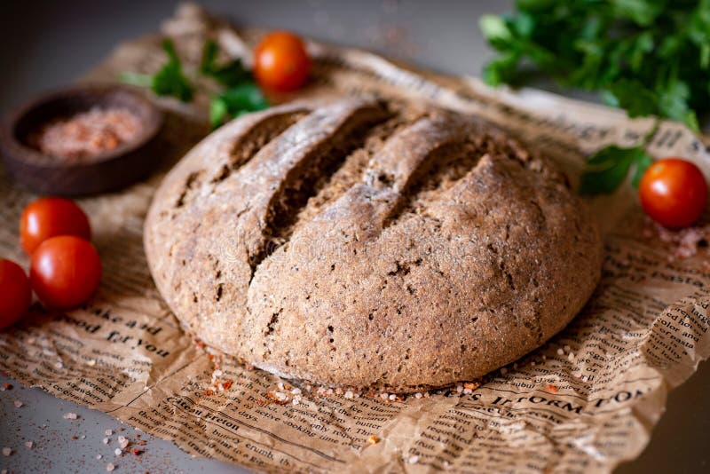 Homemade Rye Bread. a Loaf of Homemade Bread on a Newspaper. Close-up ...