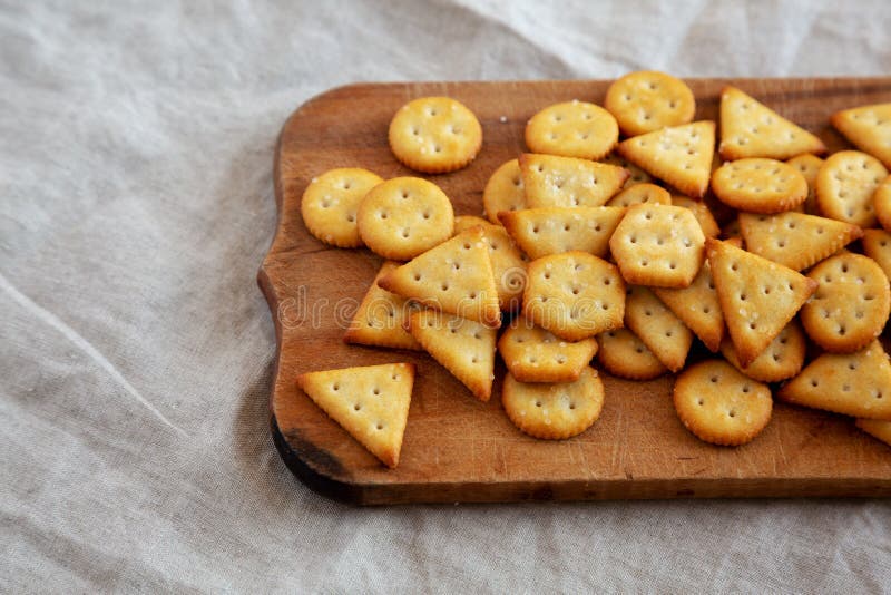Homemade Salty Crackers on a Rustic Wooden Board, Low Angle View. Space ...