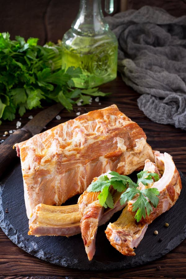 Homemade Smoked Pork Ribs Whole and Cut in Slices on the Rustic Kitchen ...