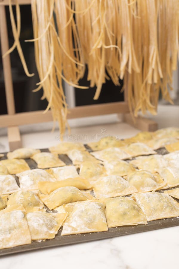 Homemade Spaghetti Drying on a Pasta Rack and Ravioli Ready To B Stock ...
