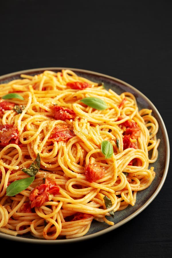 Homemade Spaghetti Pasta with Fresh Tomato Sauce on a Plate on a Black ...