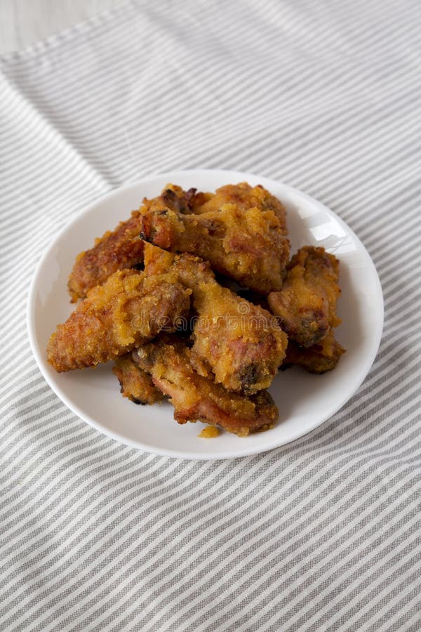 Homemade Spicy Mango Chicken Wings on a White Plate on Cloth, Low Angle ...