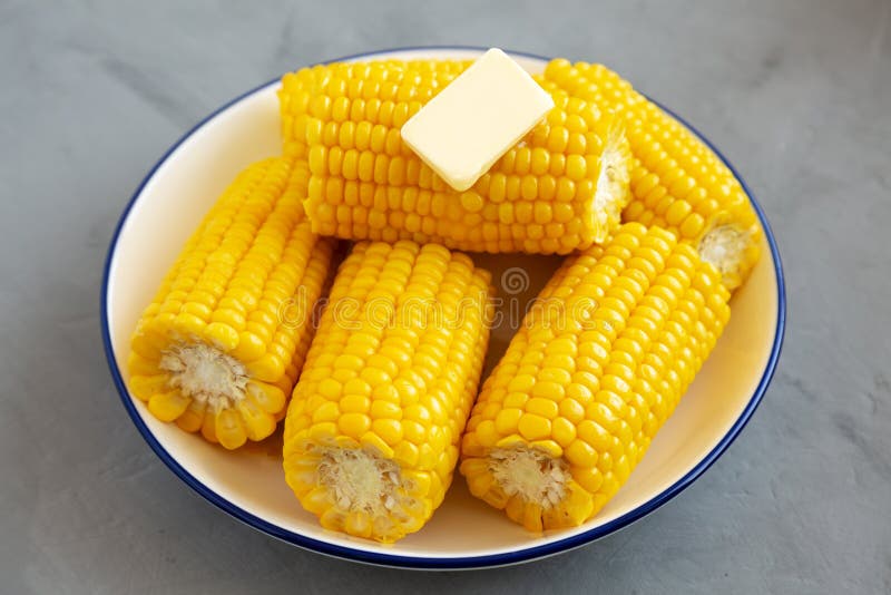 Homemade Steamed Corn on the Cob with Butter on a Plate, Side View ...
