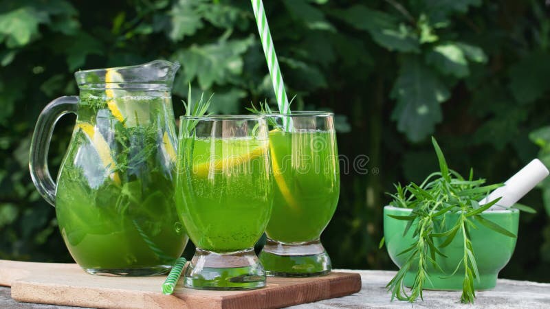 Homemade Summer Refreshing Tarragon Lemon Drink on Patio Table Stock ...