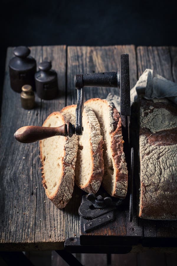 Homemade Tasty Loaf of Bread and Old Slicer Stock Image - Image of ...