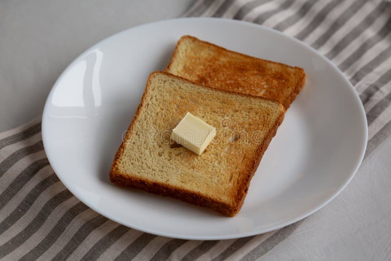 Homemade Toasted Bread Slice with Butter on a Plate, Side View Stock ...