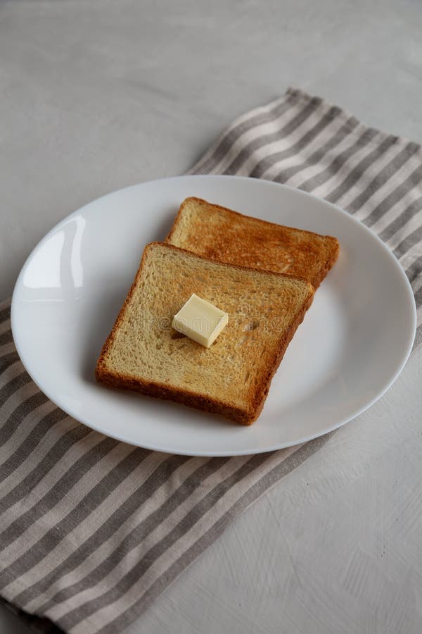 Homemade Toasted Bread Slice with Butter on a Plate, Side View Stock ...