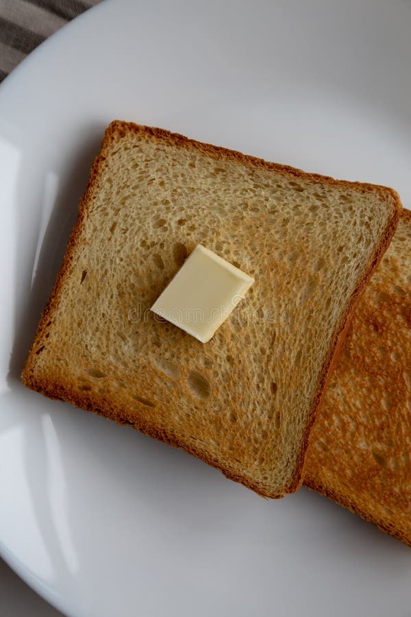 Homemade Toasted Bread Slice with Butter on a Plate, Top View Stock ...
