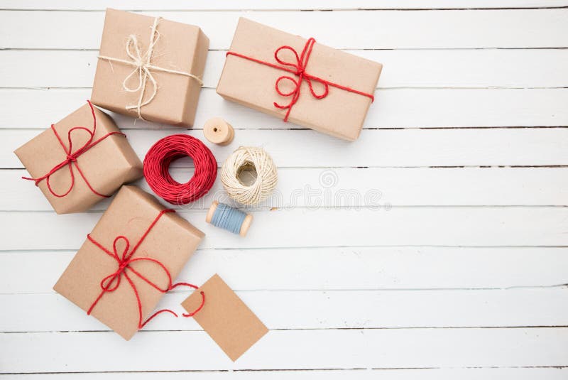 Homemade Wrapped Rustic Brown Paper Packages on White Wooden Surface ...