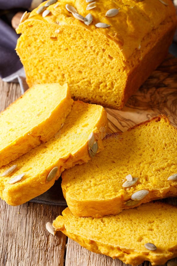 Homemade Yellow Pumpkin Bread with Seeds Macro on the Table. Vertical ...
